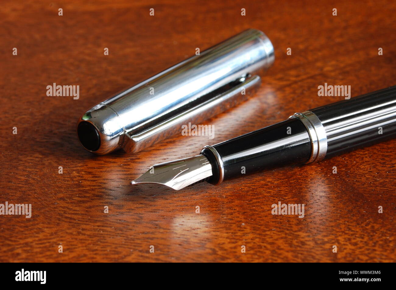 business fountain pen on a wood desktop in an office Stock Photo - Alamy