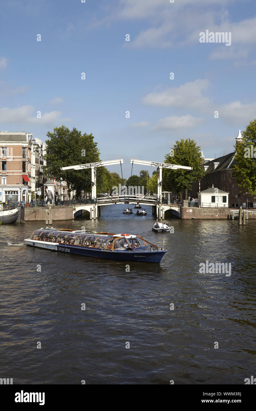 Amsterdam - drawbridge with excursion ship Stock Photo - Alamy