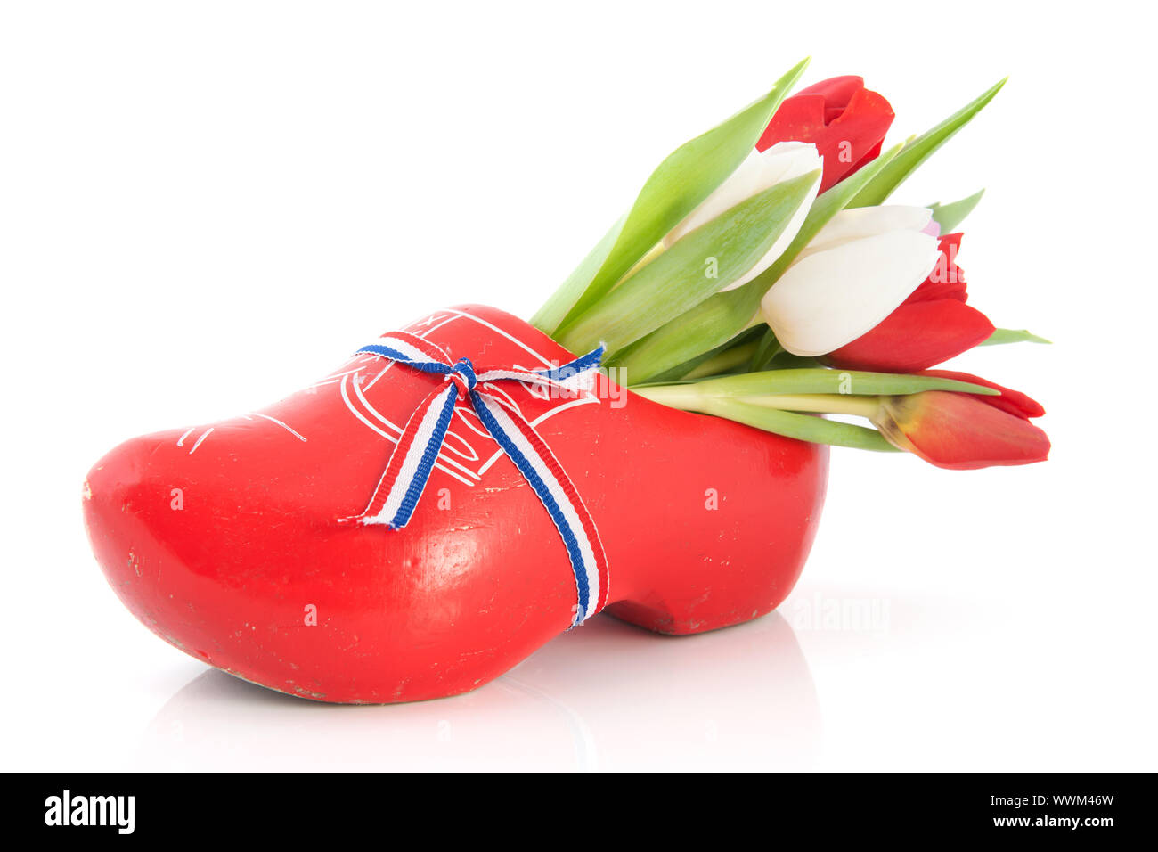 Red Dutch wooden clogs with colorful tulips Stock Photo - Alamy
