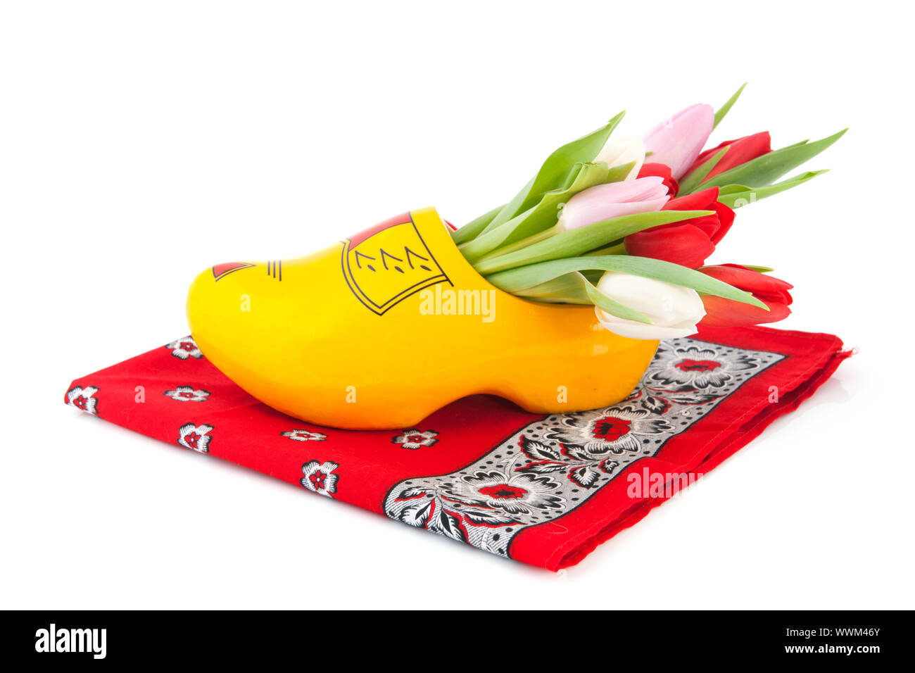 Yellow Dutch wooden clogs with colorful tulips Stock Photo - Alamy