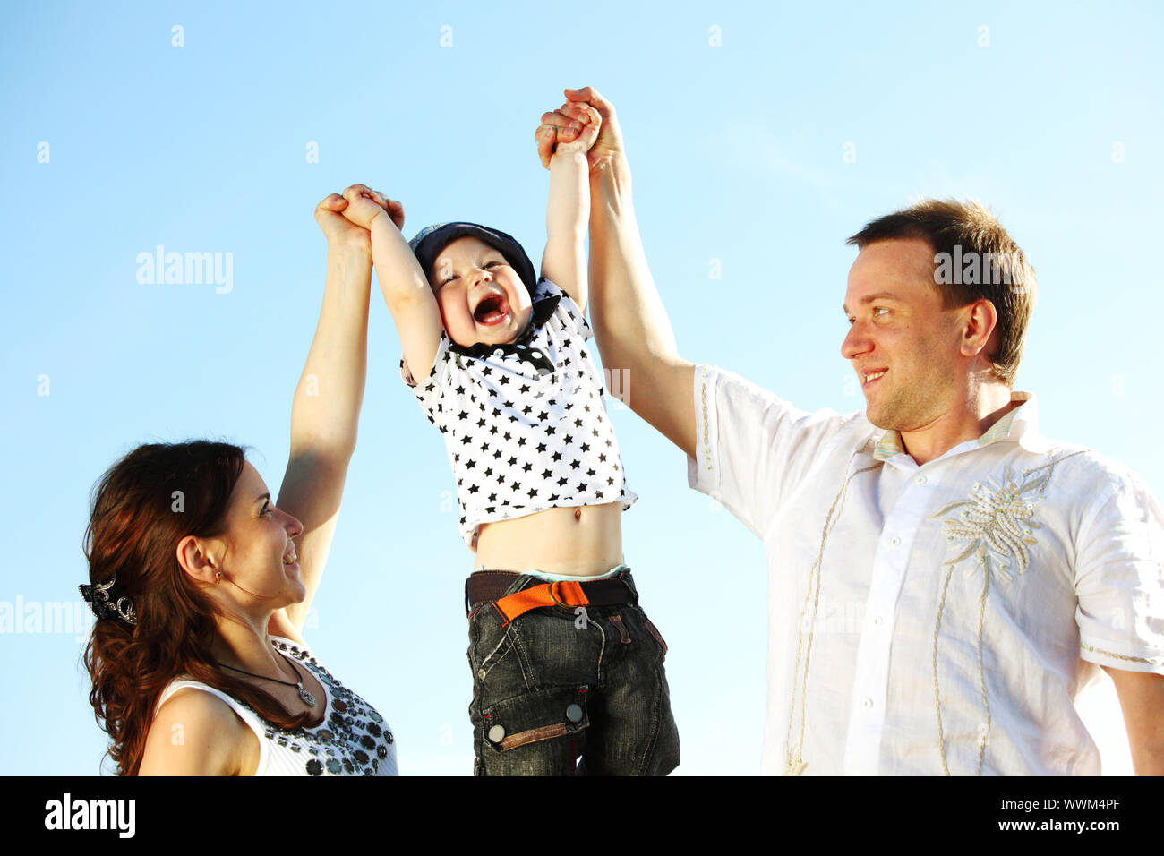 happy family on blue sky background Stock Photo - Alamy