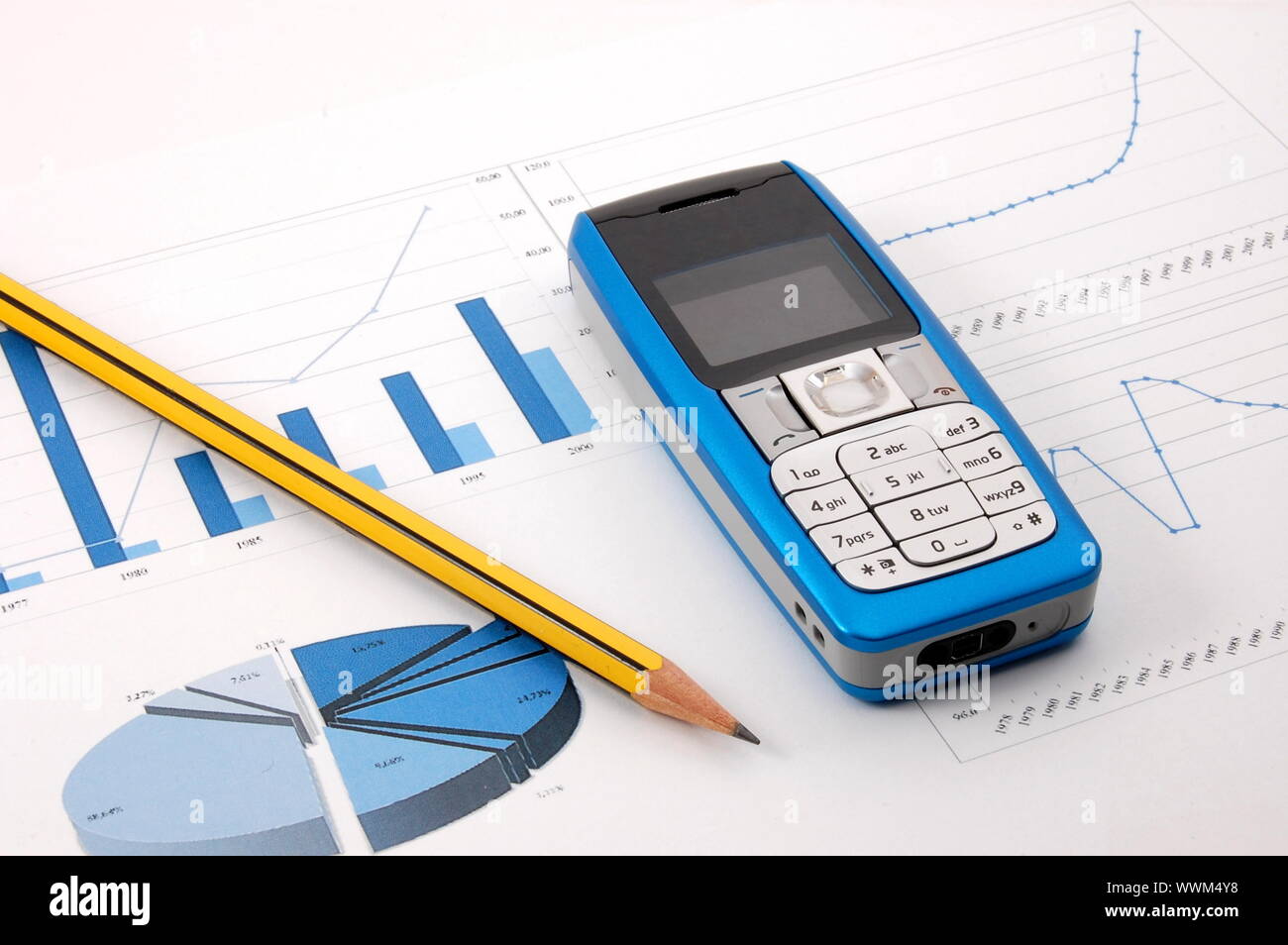 blue cell phone over business chart showing success Stock Photo - Alamy