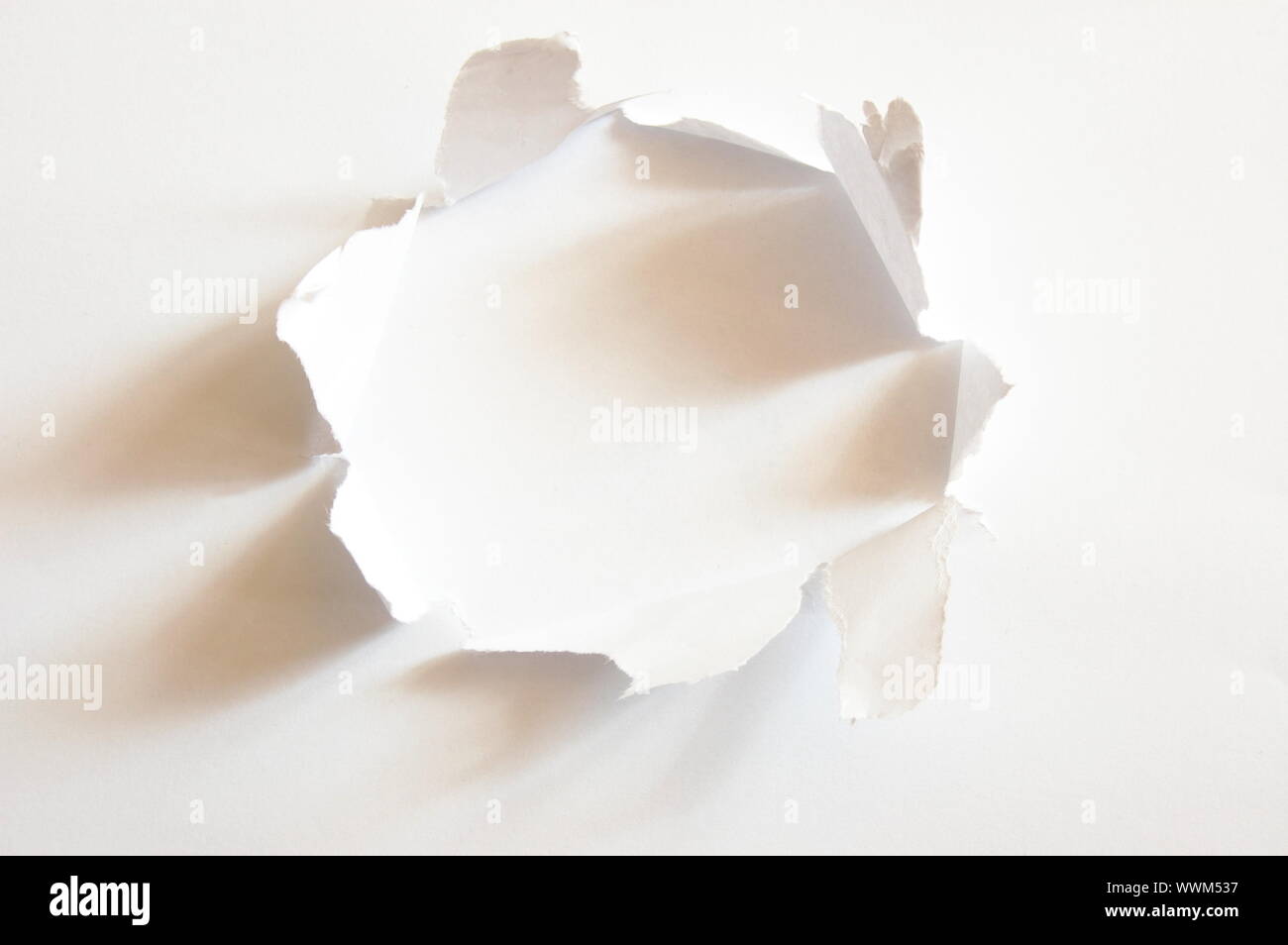 hole with copyspace in blank sheet of paper Stock Photo - Alamy