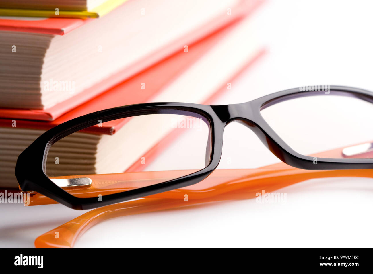 books and glasses closeup on white background Stock Photo - Alamy