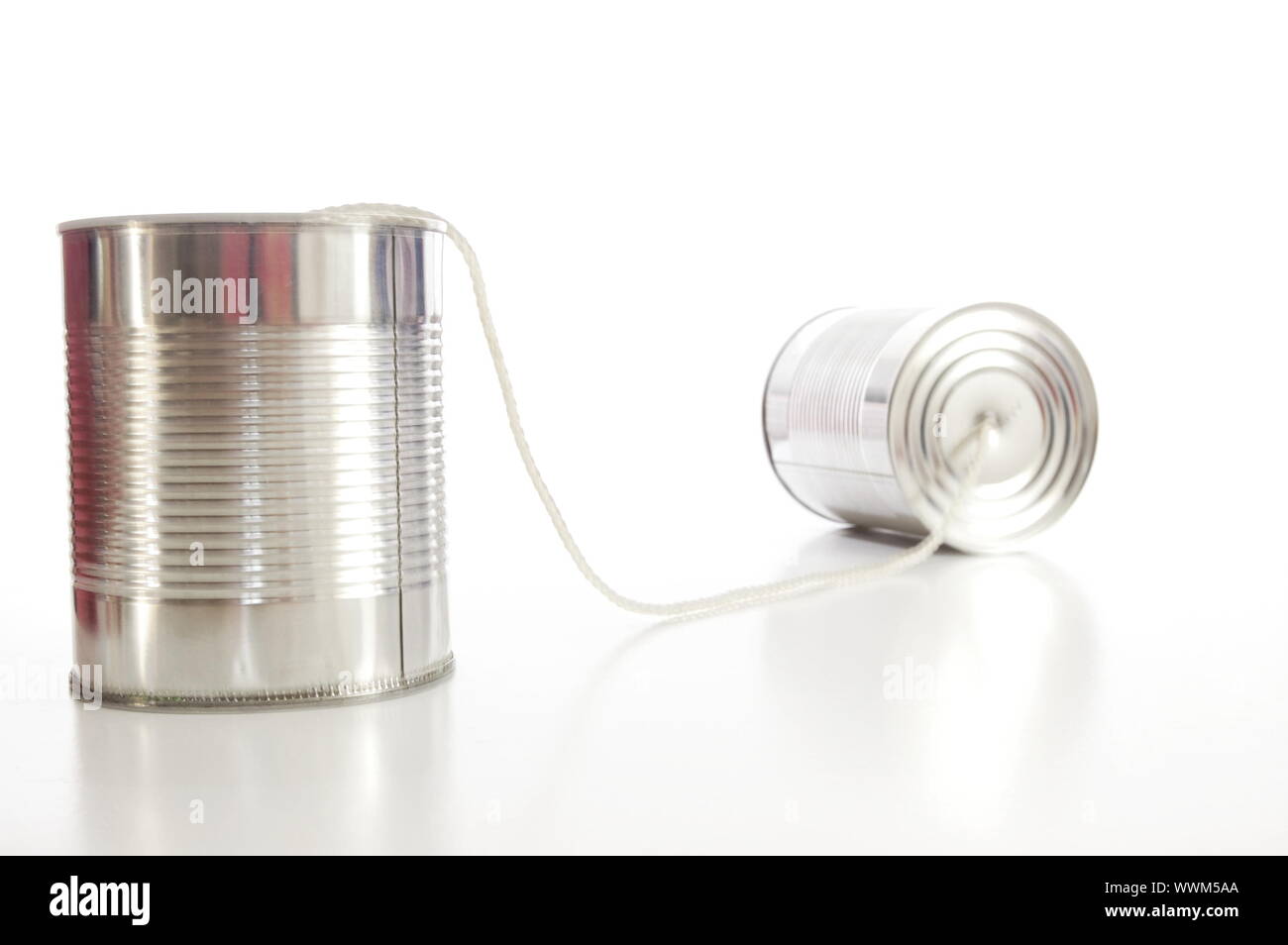 isolated tin or can telephone showing communication Stock Photo - Alamy