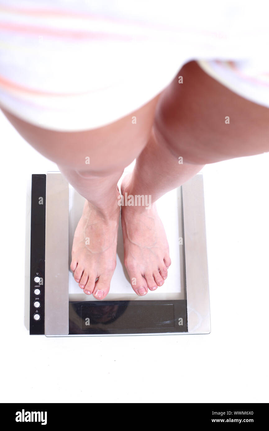 legs on scales isolated on white background Stock Photo - Alamy
