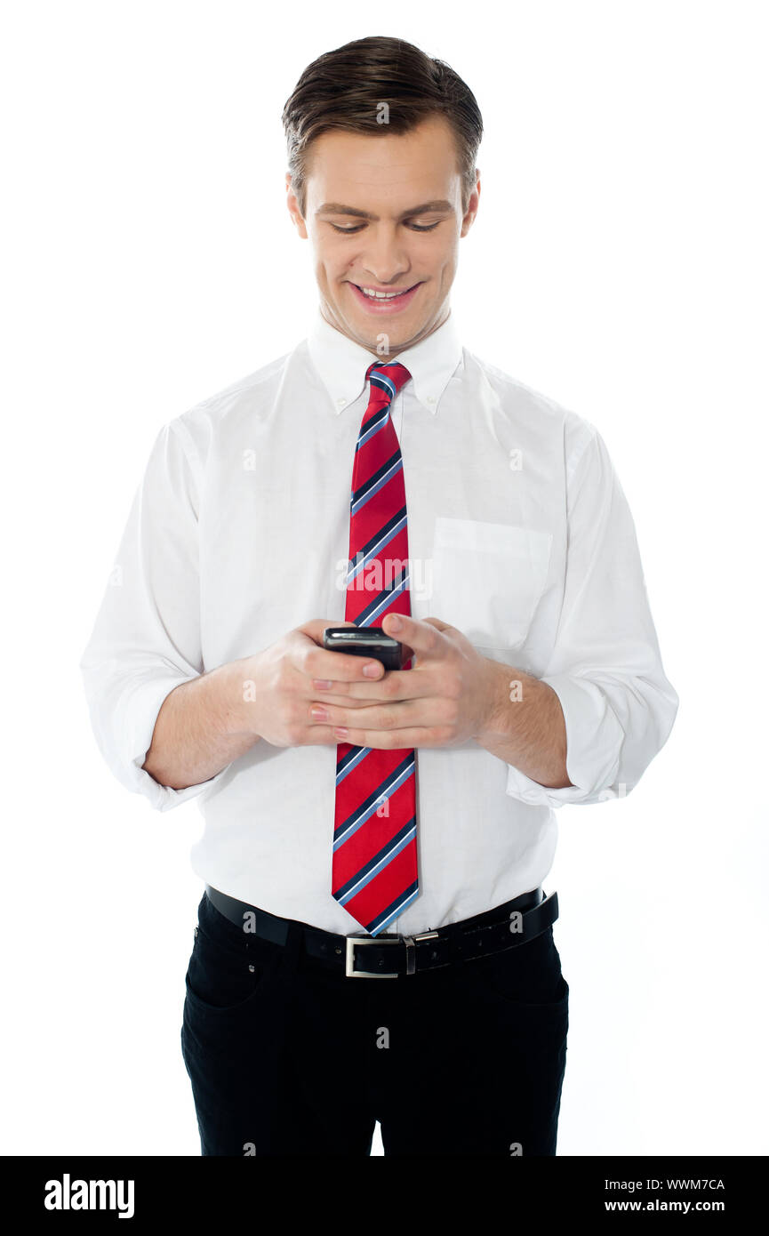 Happy business person busy texting against white background Stock Photo ...