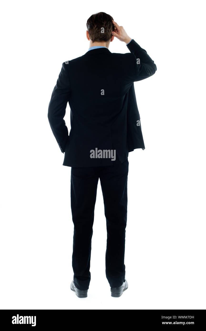 Back-pose of a corporate person thinking hard isolated over white ...