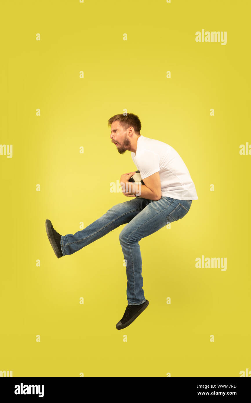 Full length portrait of happy jumping man isolated on yellow background ...