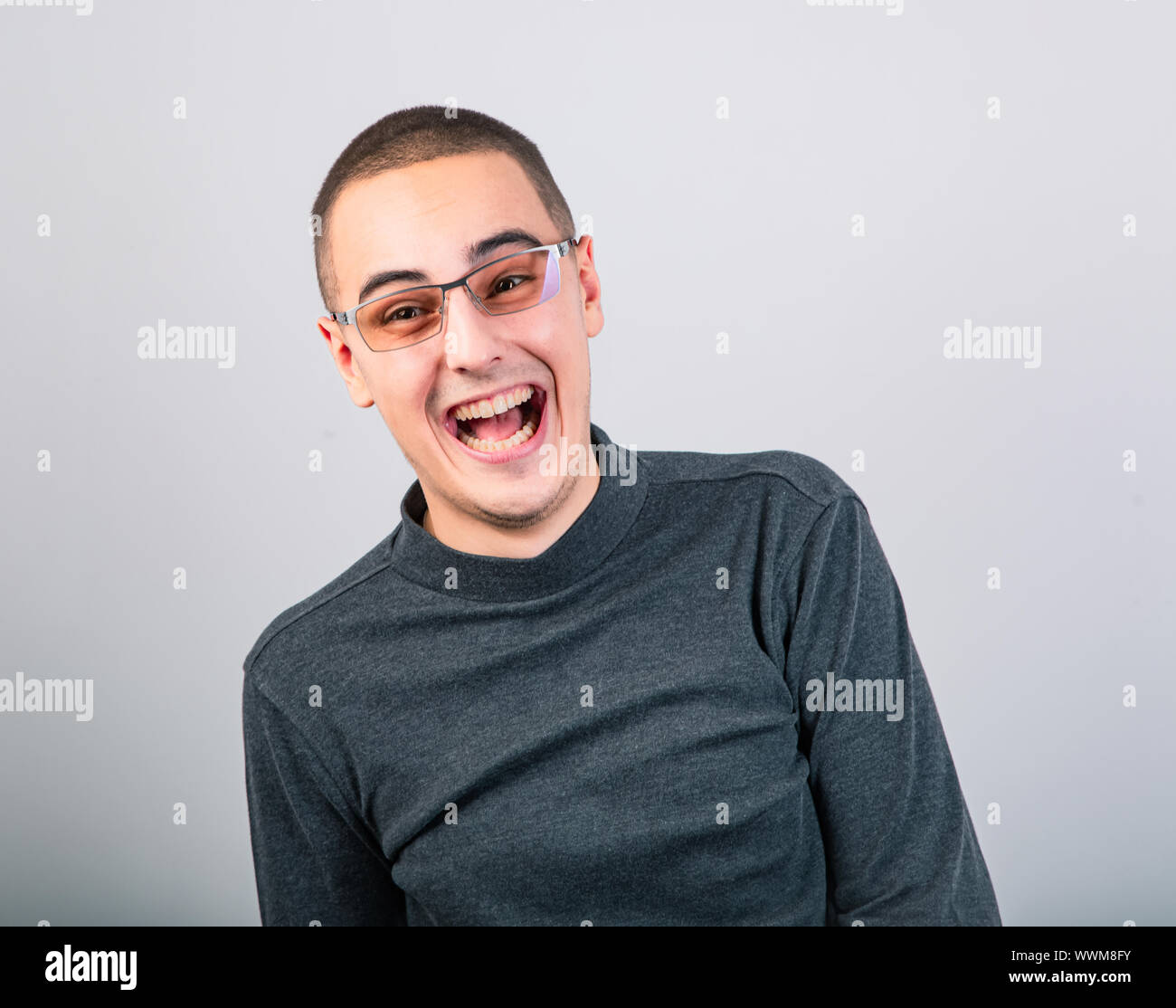Crazy casual laughing man in eye glasses with wide open mouth on blue ...