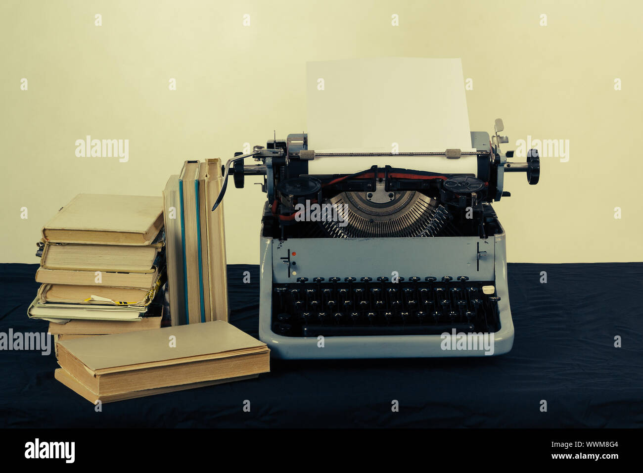 Old typewriter with books retro colors on the desk Stock Photo - Alamy