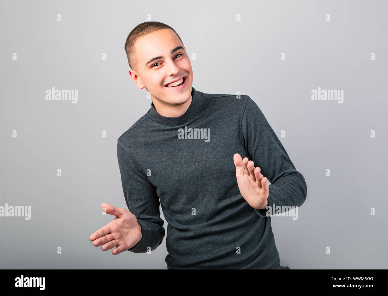 Happy smiling young man clapping one's hands on blue background ...