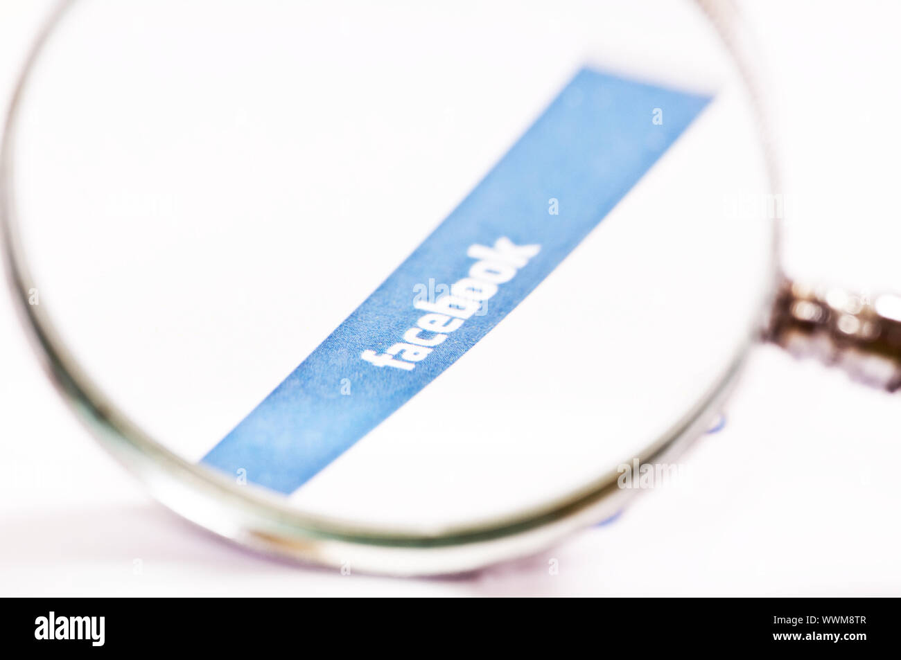 Facebook under the magnifying glass Stock Photo - Alamy