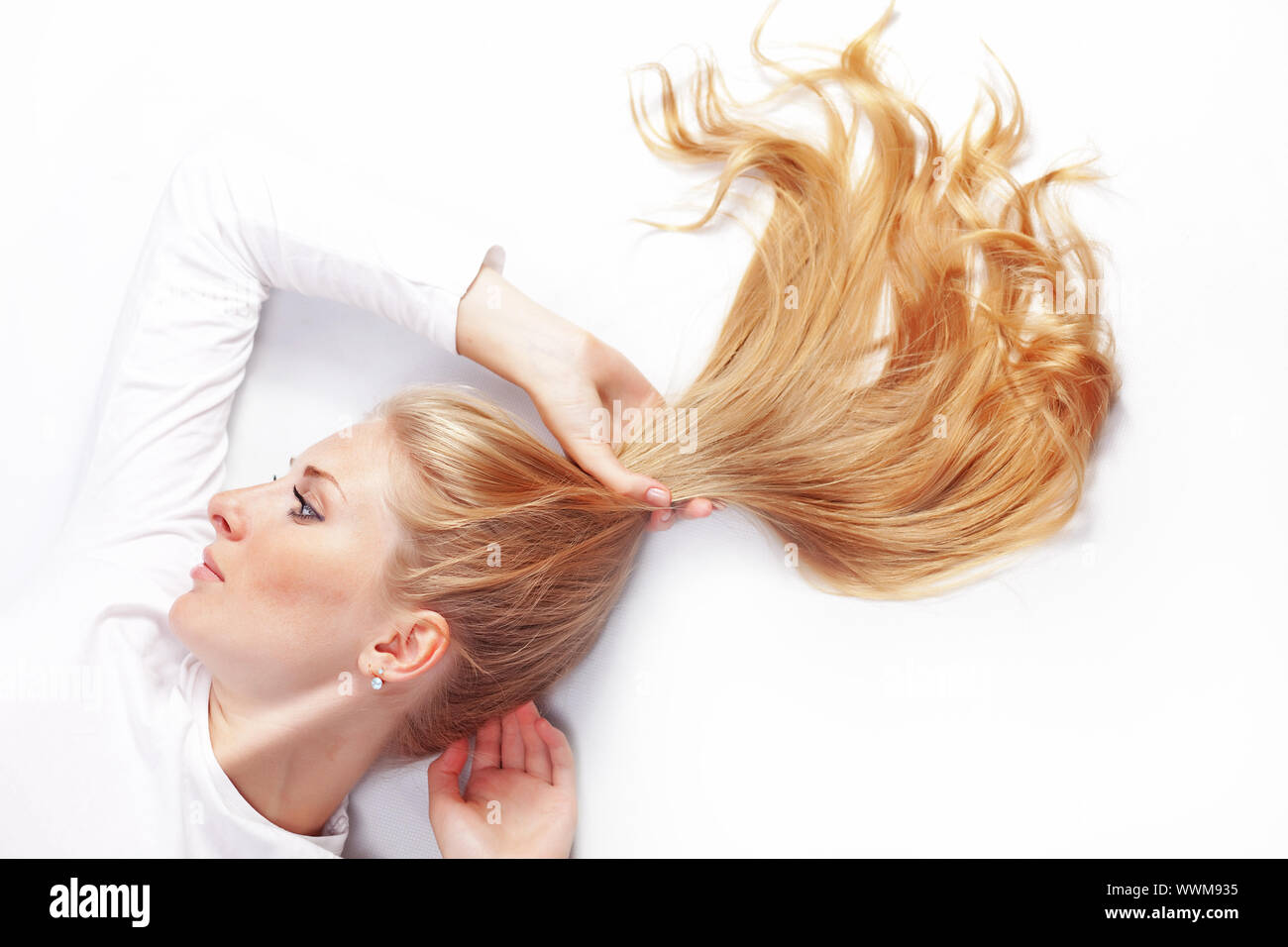 Studio portrait of beautiful young woman with long gold hair Stock ...
