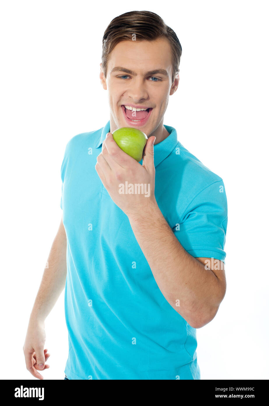 Young caucasian biting an apple on white background Stock Photo - Alamy
