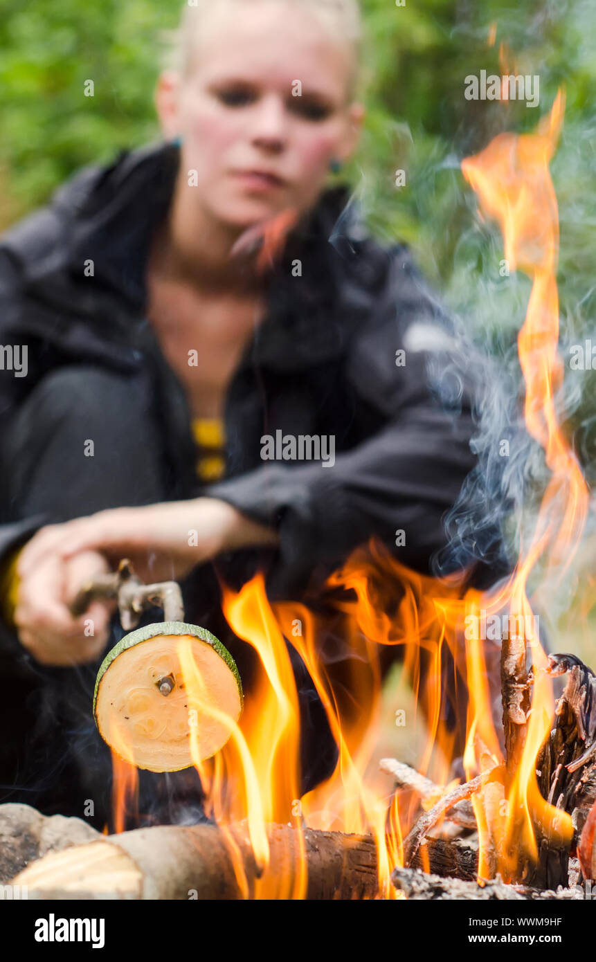 blonde young woman at the campfire Stock Photo - Alamy