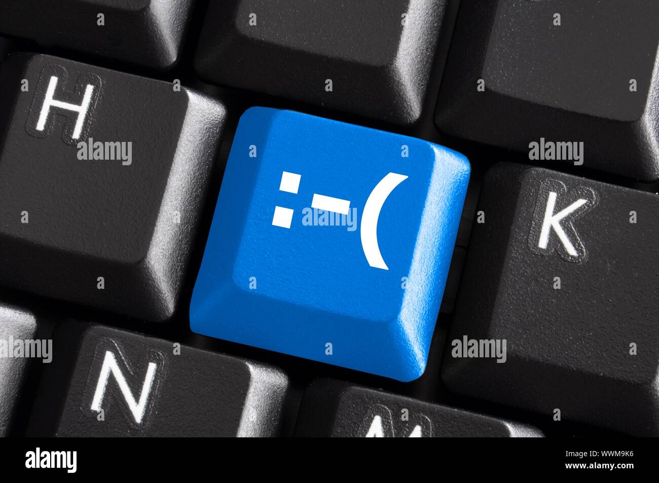 negative smilie on blue computer keyboard button showing bad feelings ...