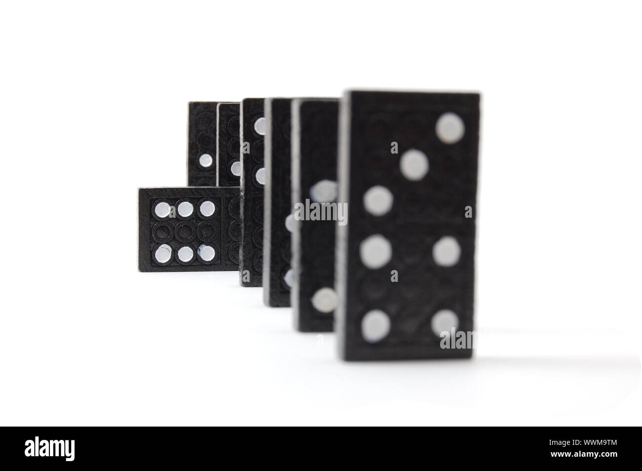 row of dominoes including a special domino stone isolated on white ...