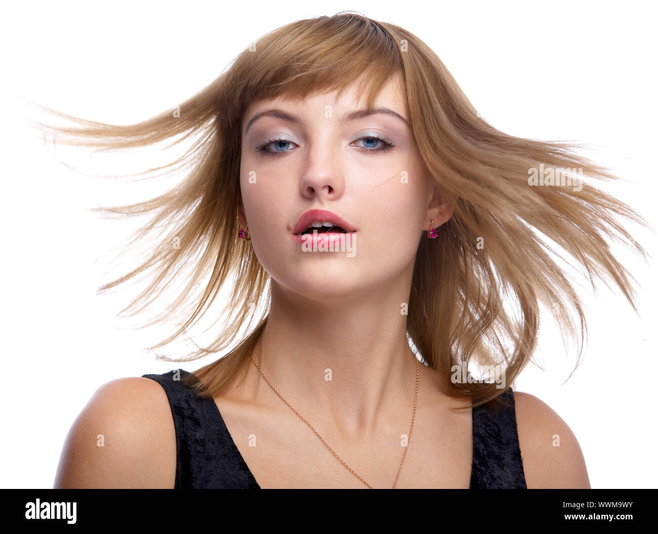 portrait of beautiful blue-eyed model turns her head and her hair ...
