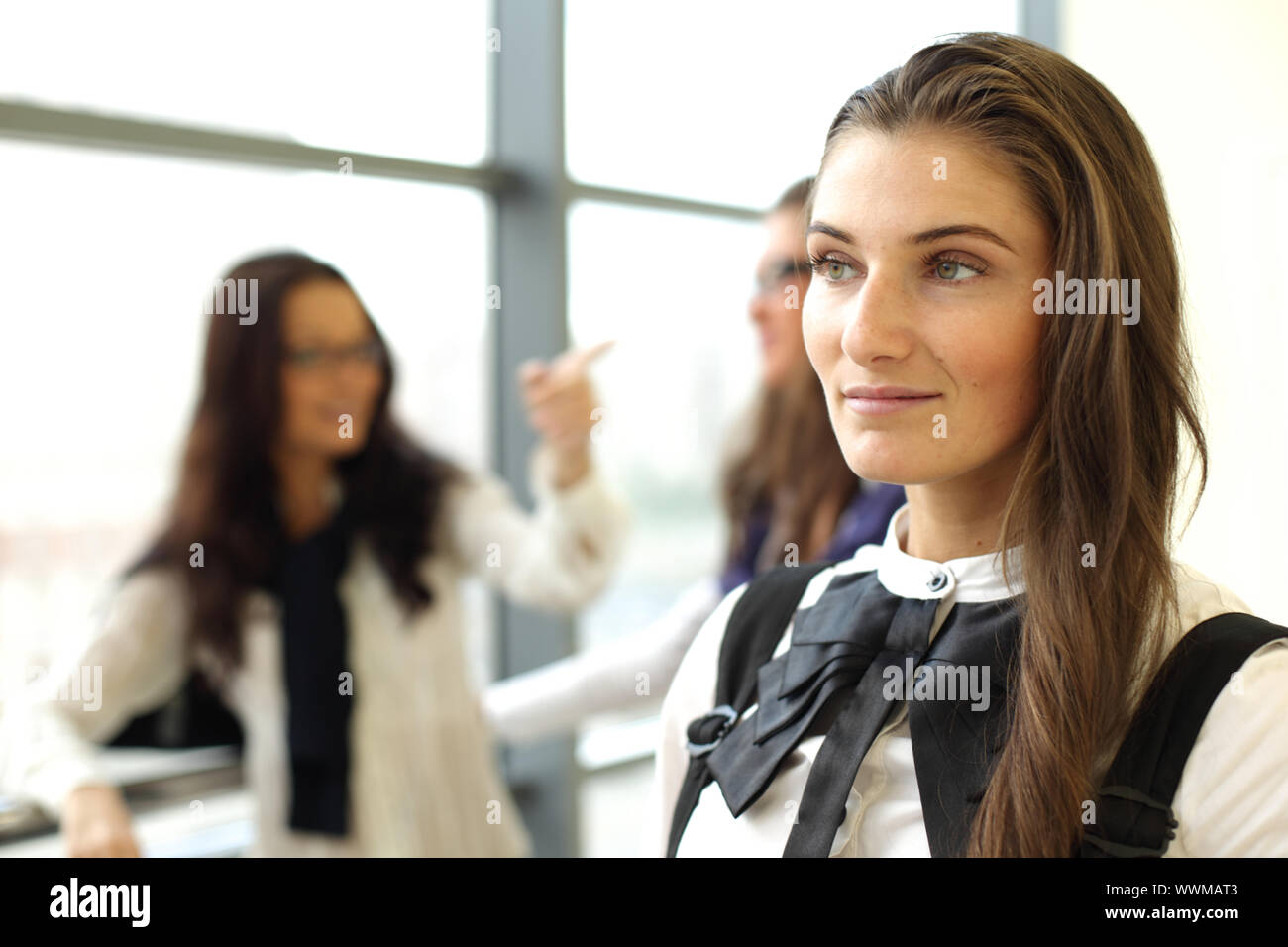Student meeting smiley girl face on foreground Stock Photo - Alamy
