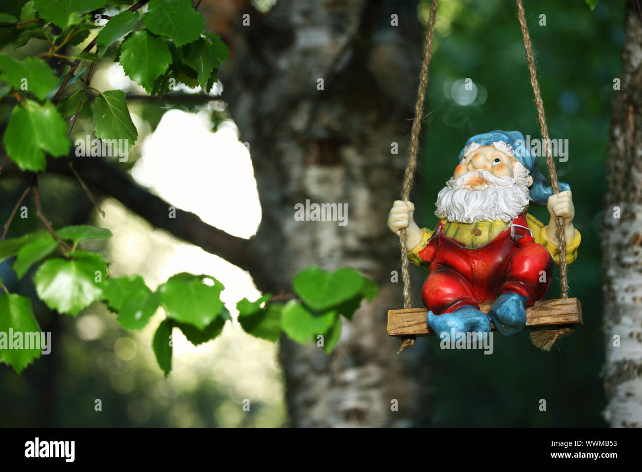 garden dwarf on green nature background Stock Photo - Alamy