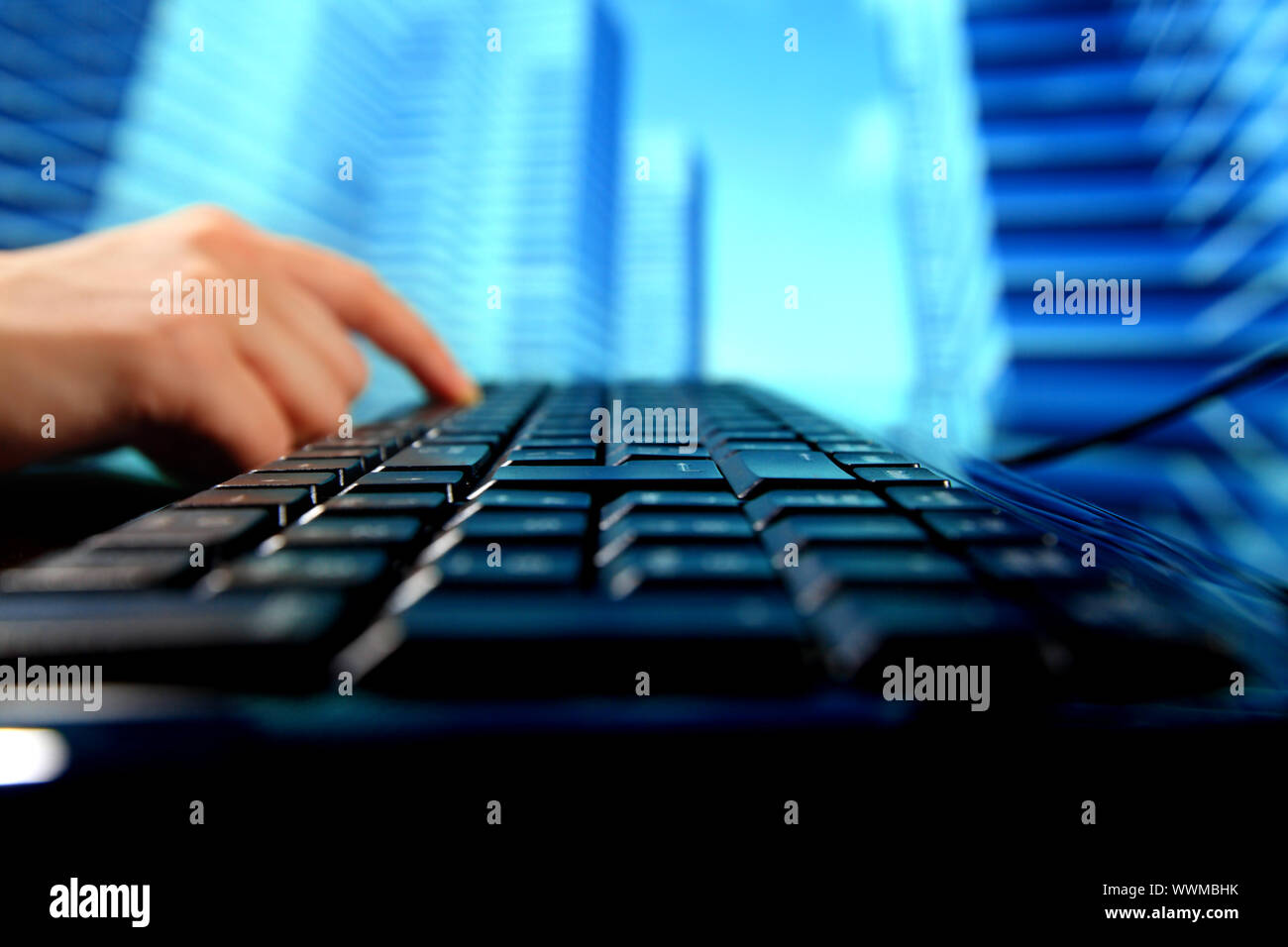 reseller work on keyboard skyscrapers on background Stock Photo - Alamy