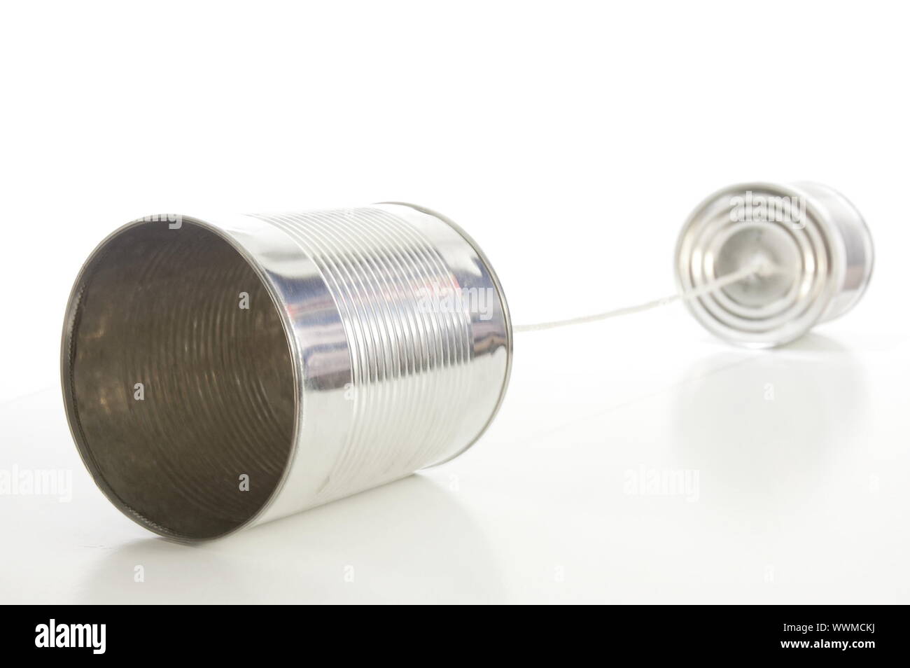 isolated tin or can telephone showing communication Stock Photo - Alamy