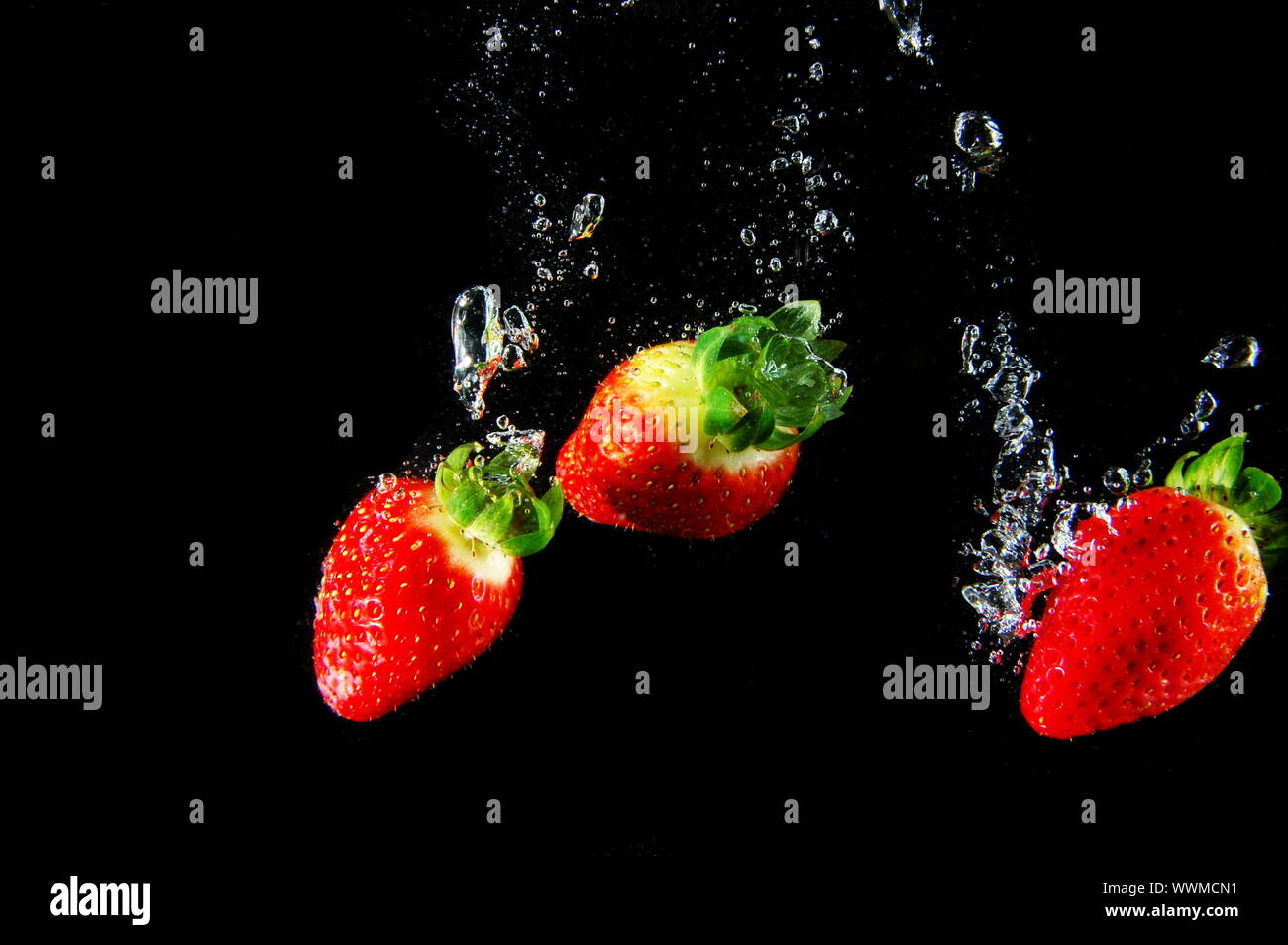 strawberry splashing in water in white background Stock Photo - Alamy