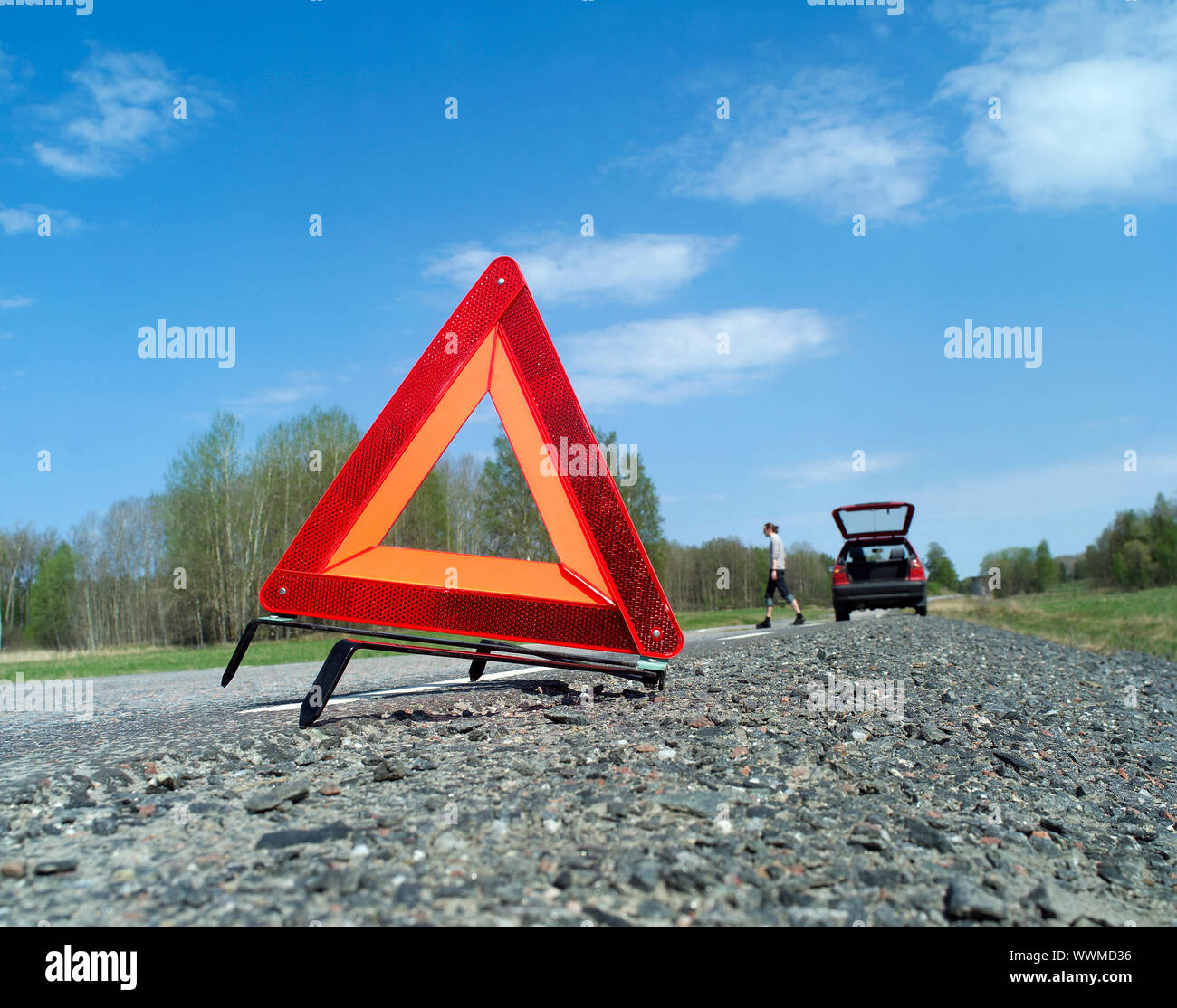 Warning traingle at the side of the road Stock Photo - Alamy