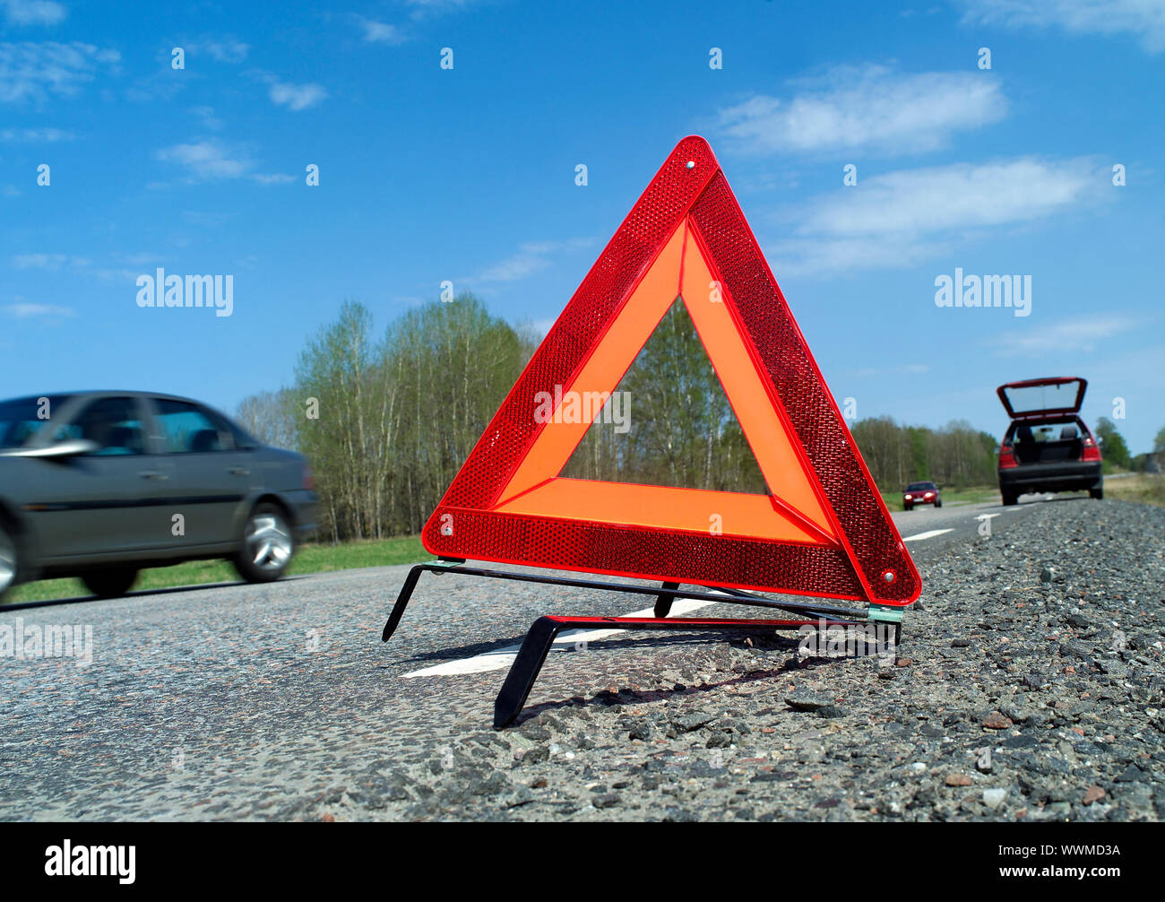 Warning traingle at the side of the road Stock Photo - Alamy