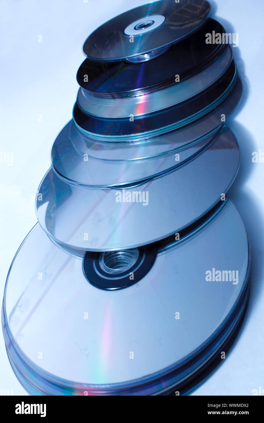 Heap of CD on the white background in vertical line Stock Photo - Alamy