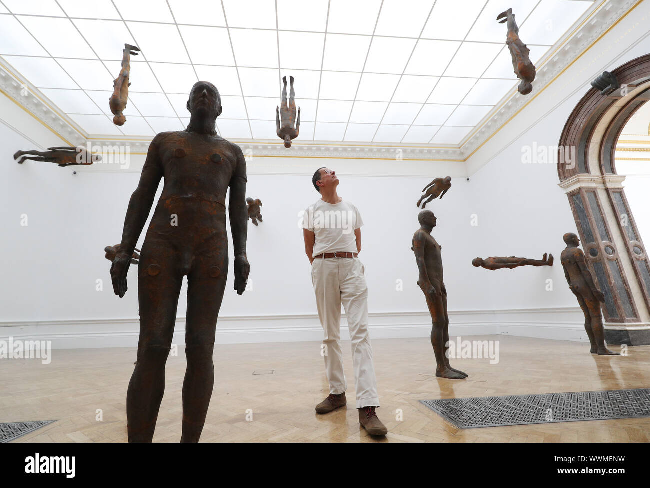 British sculptor Antony Gormley poses with his installation of 24 ...