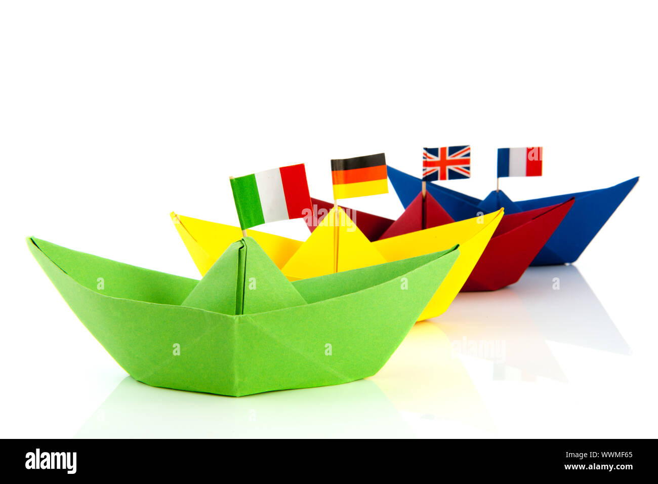 Colorful folded paper boats with European flags isolated over white ...