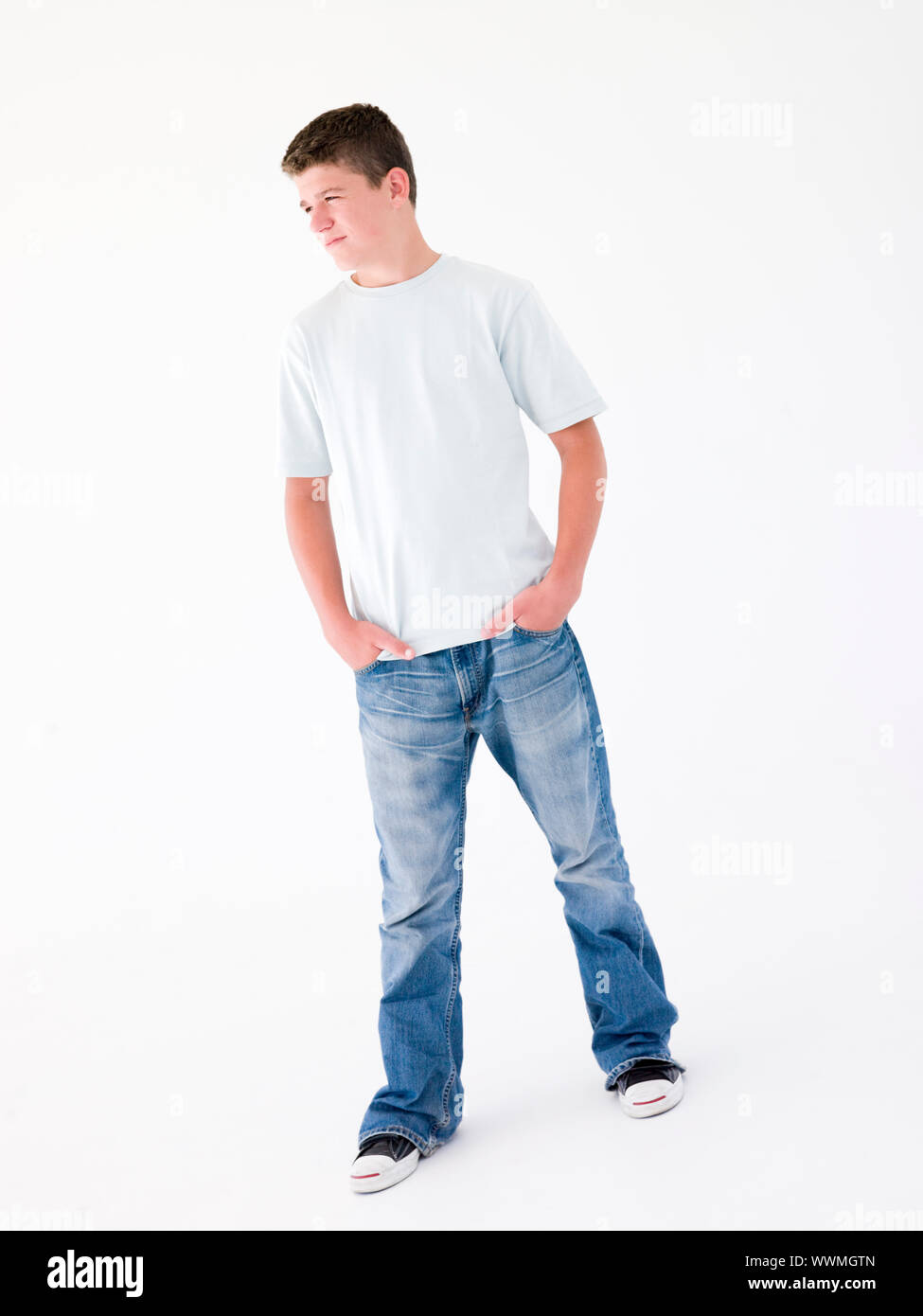 Teenage boy standing with hands in pockets Stock Photo - Alamy