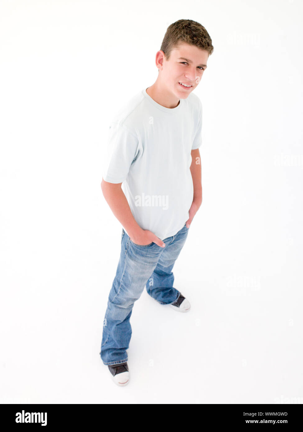 Teenage boy standing with hands in pockets Stock Photo - Alamy
