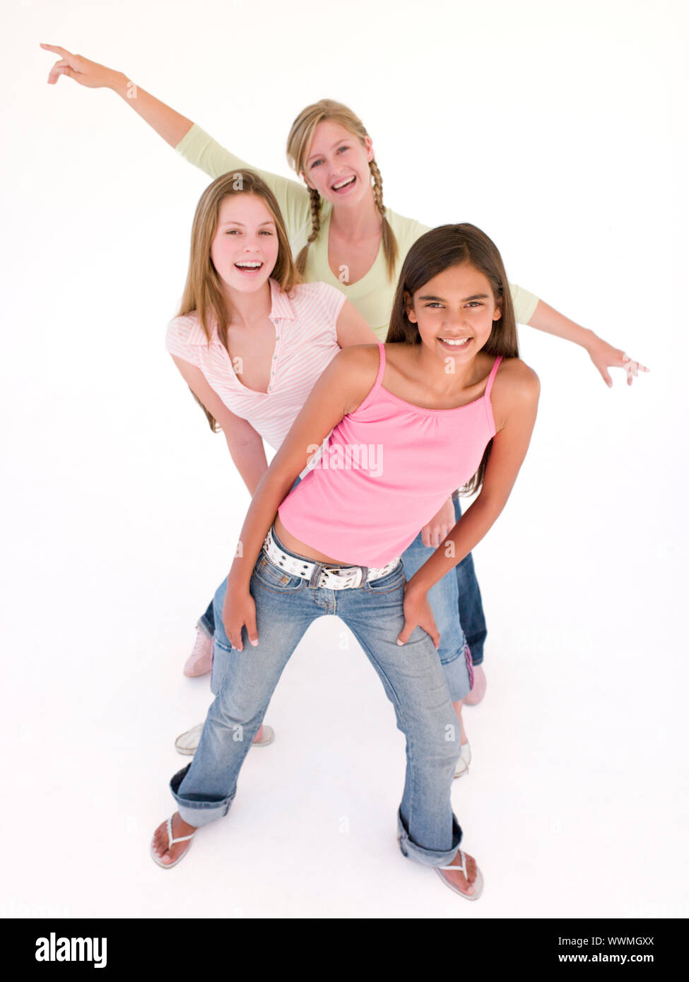 Three girl friends in a row smiling Stock Photo - Alamy