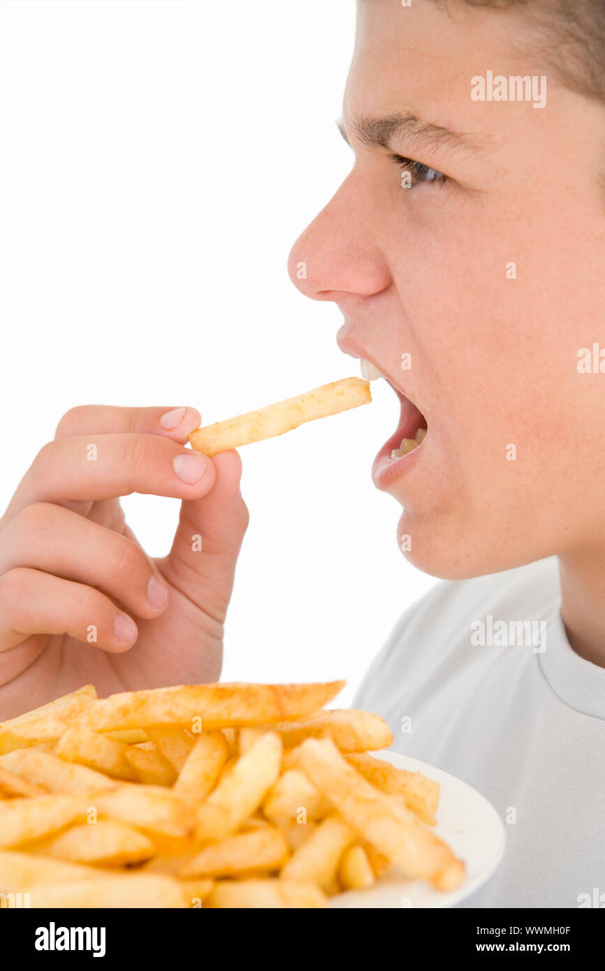 Boy eating French fries Stock Photo - Alamy
