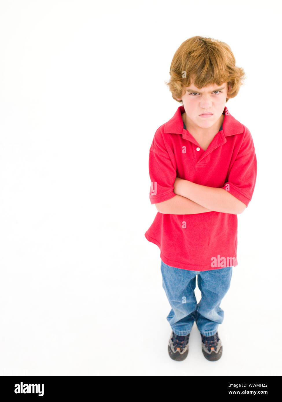 Young boy with arms crossed angry Stock Photo - Alamy