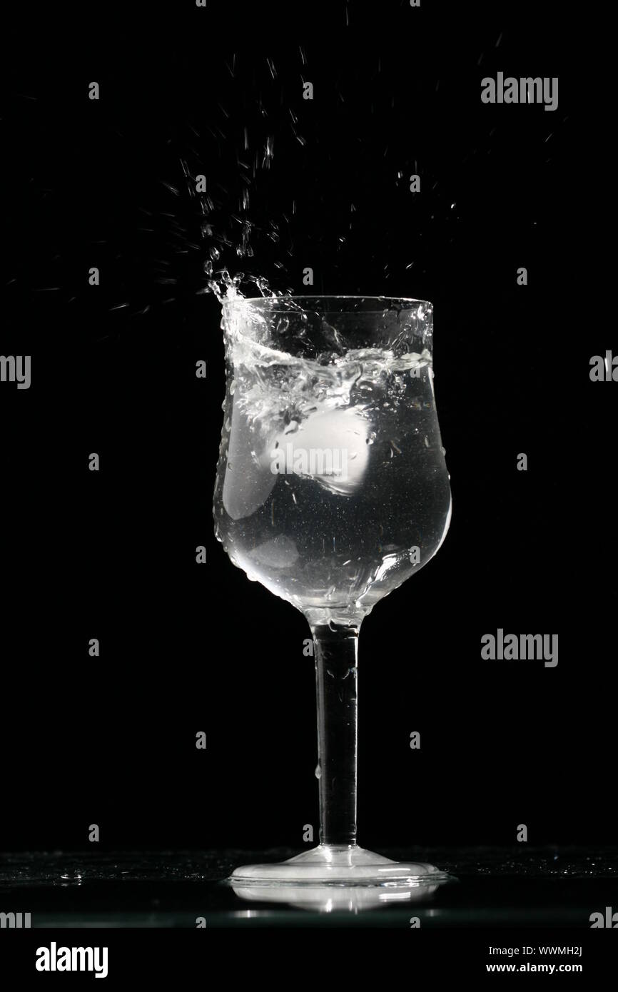 alcohol splash on black background Stock Photo - Alamy