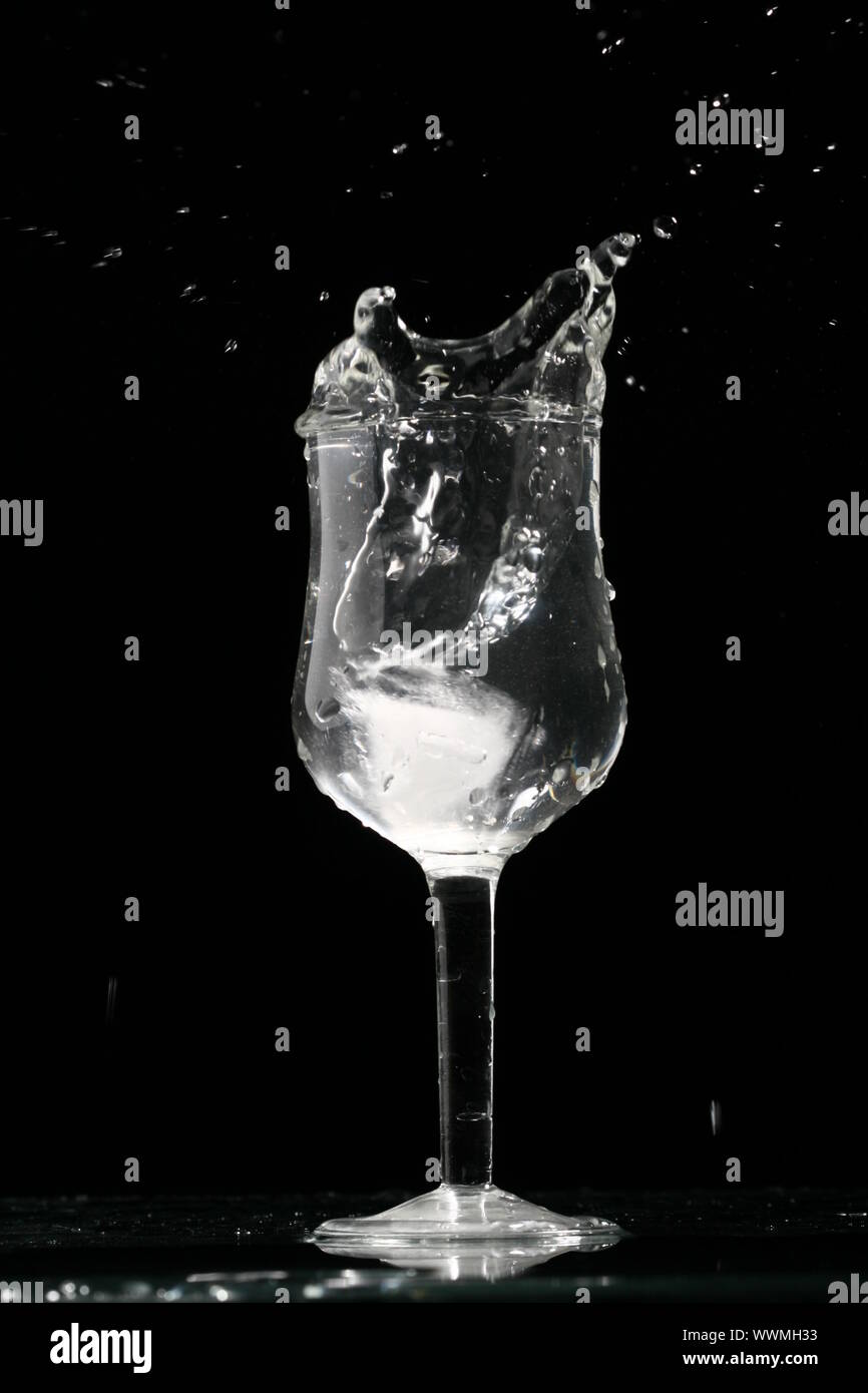 alcohol splash on black background Stock Photo - Alamy