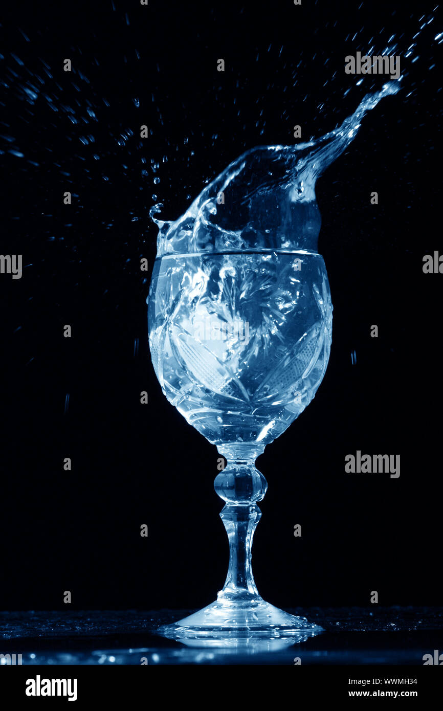 alcohol splash on black background Stock Photo - Alamy