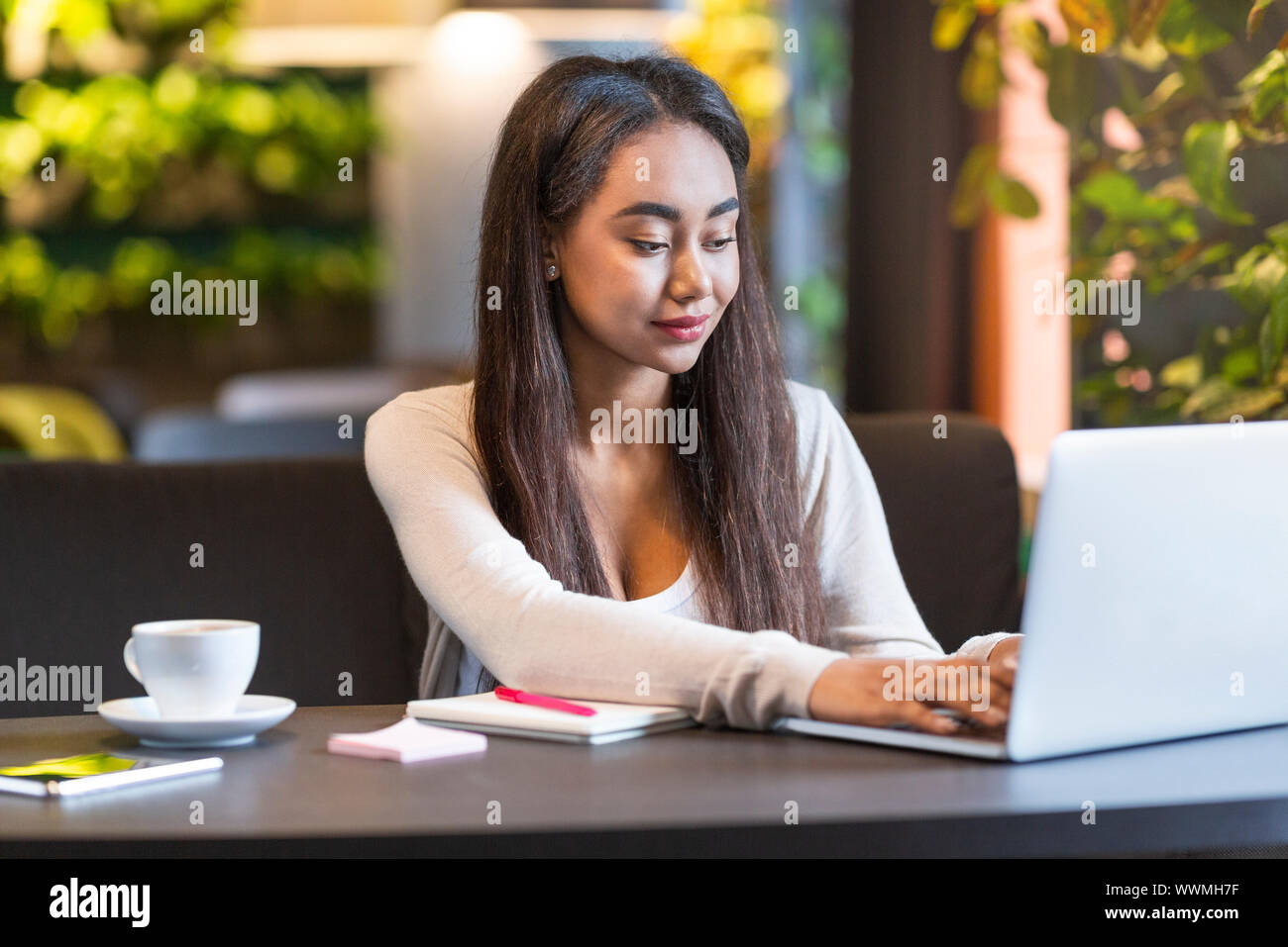 Pretty intelligent girl studying or working in cafeteria alone Stock ...