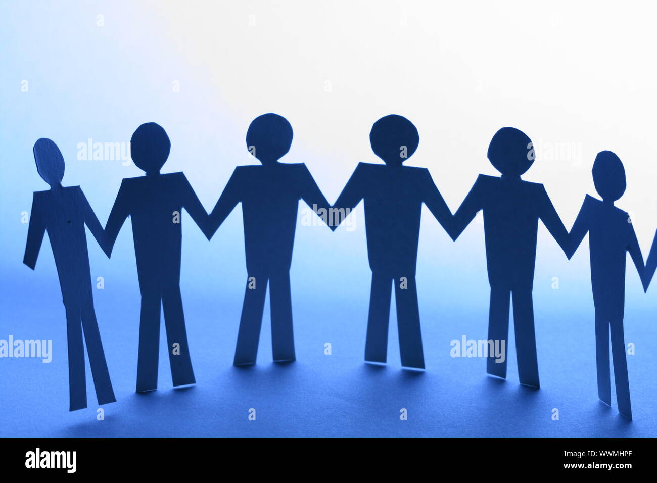 paper team linked together partnership concept Stock Photo - Alamy
