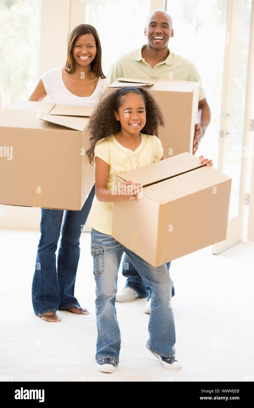 Family moving into new home smiling Stock Photo - Alamy