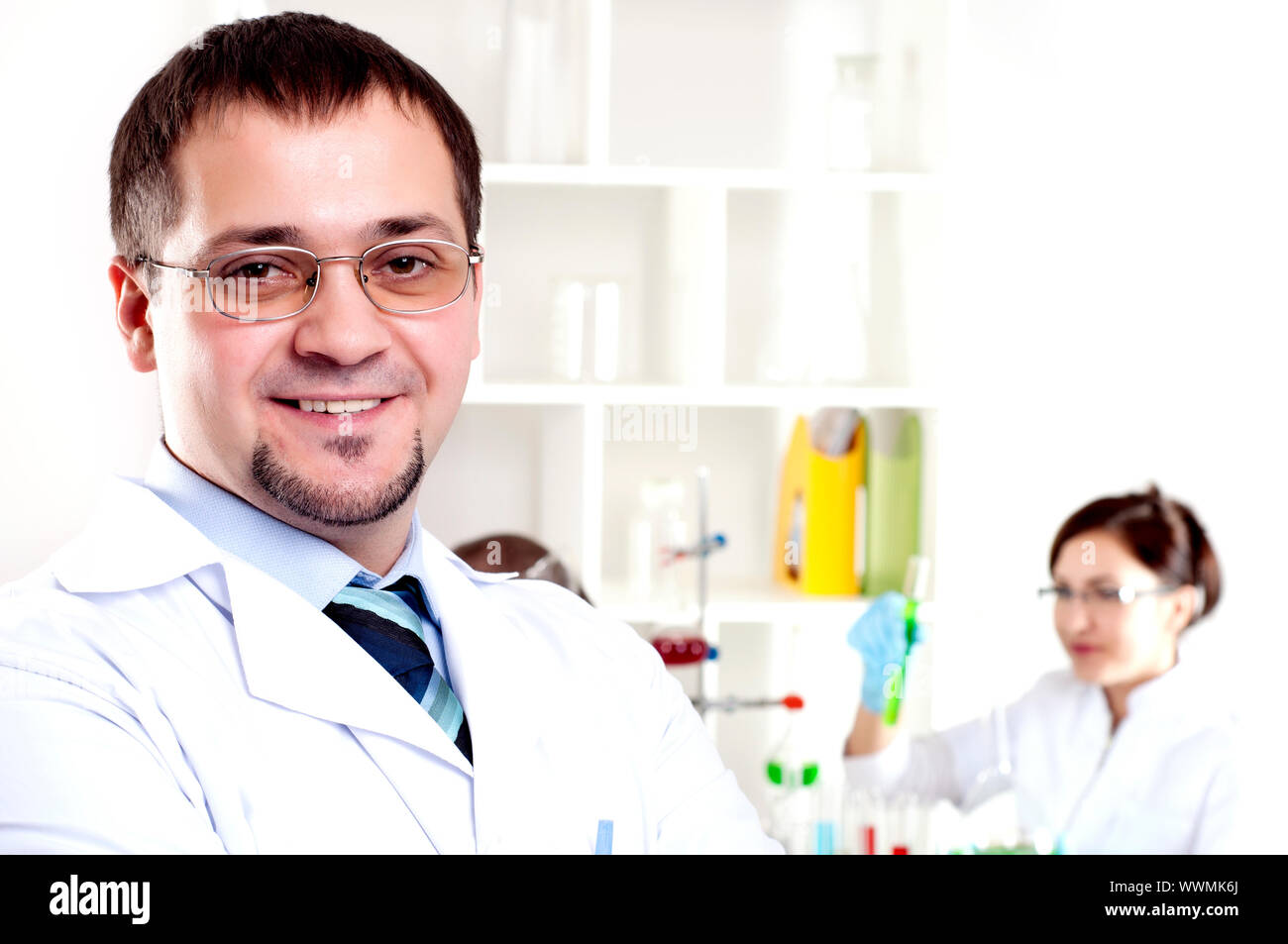 Three doctors are smiling at the camera in a doctors' office ...