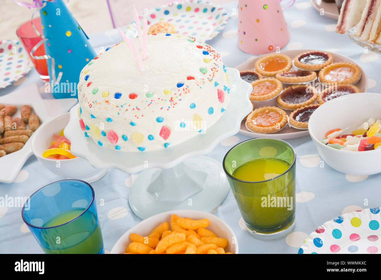 Birthday party table setting with food Stock Photo - Alamy