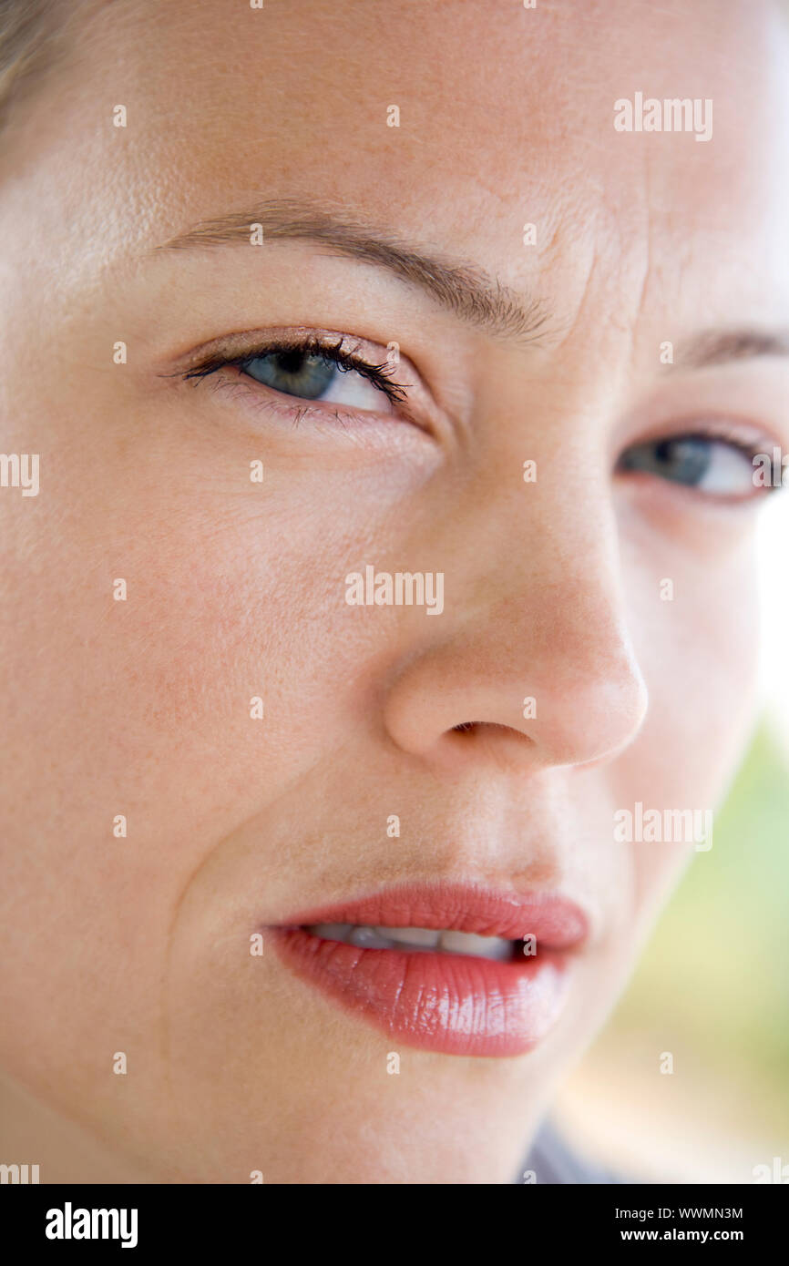 Head shot of woman scowling Stock Photo - Alamy