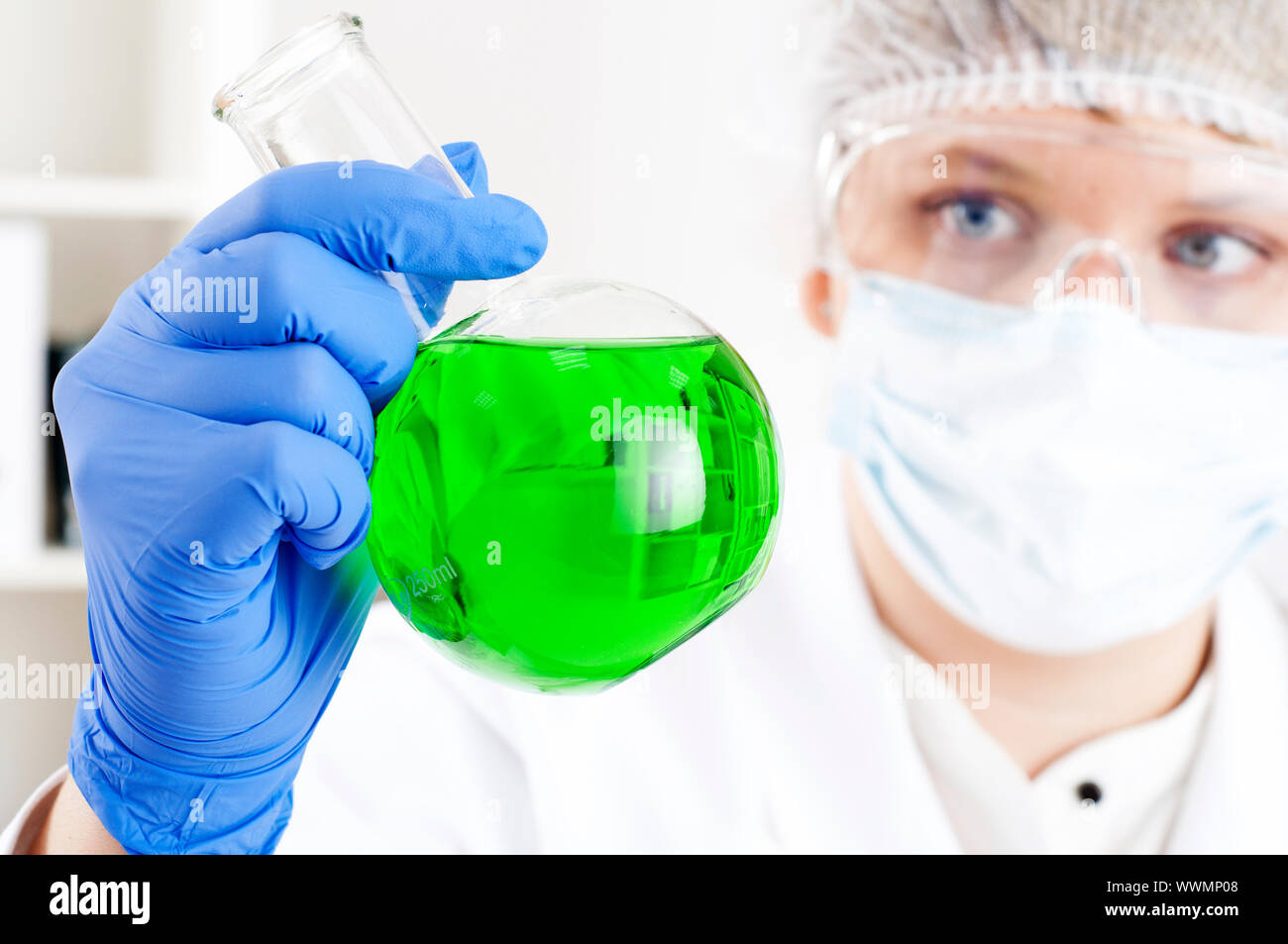 female chemist mixing liquids in test tubes, working in lab Stock Photo ...