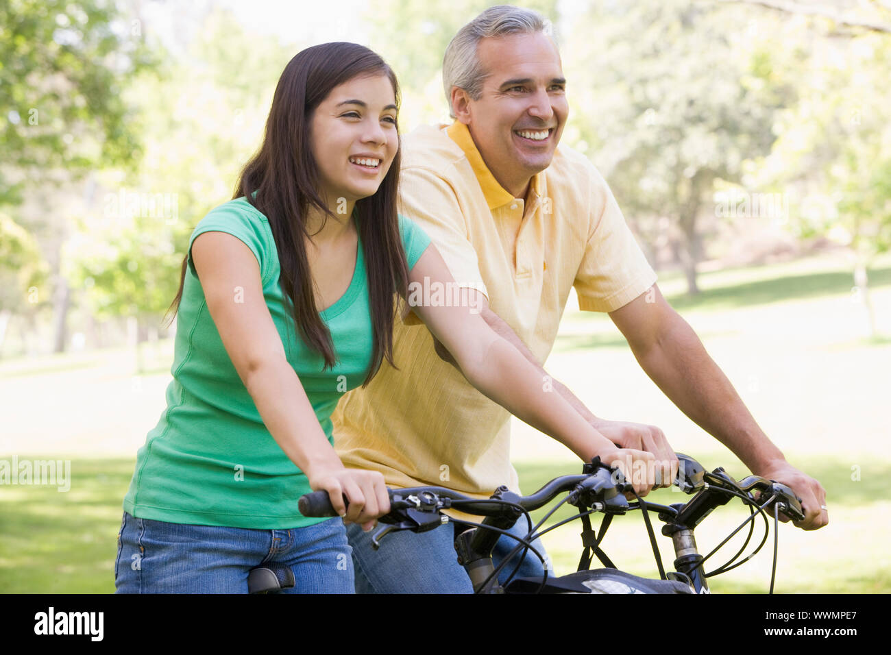 Hispanic teen riding bike hi-res stock photography and images - Alamy
