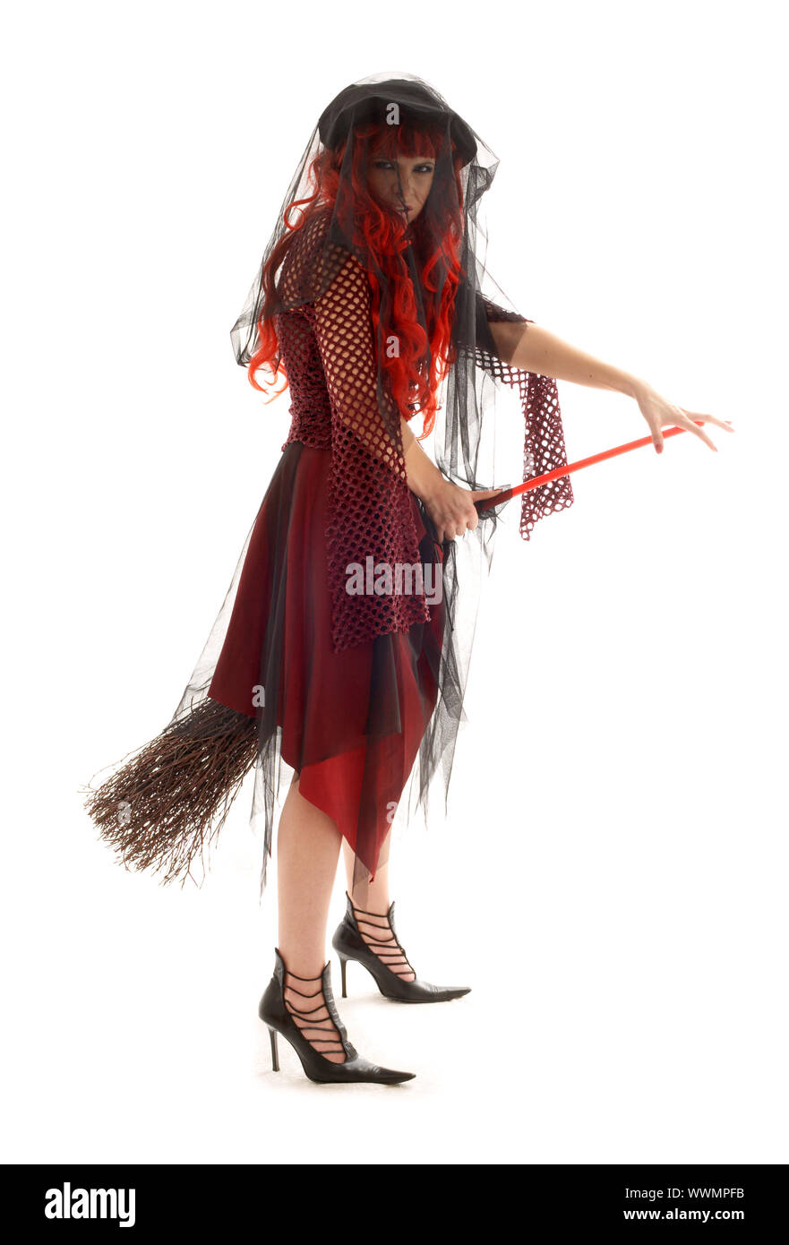 Red witch with broom costume Cut Out Stock Images & Pictures - Alamy